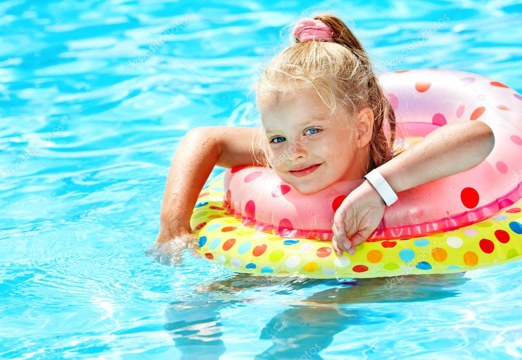 Child sitting on inflatable ring in swimming pool. — Stock Photo ...