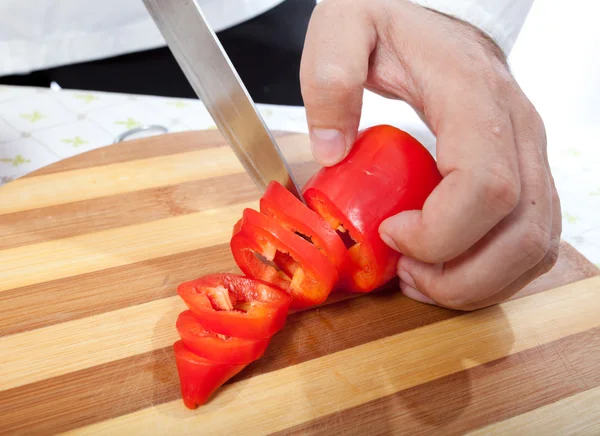 Cook hand with knife cutting vegetable - Stock Image - Everypixel