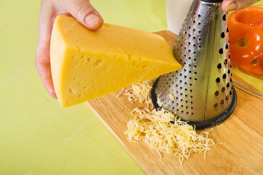 Closeup of cook grating cheese — Stock Photo © Jim_Filim #8143101