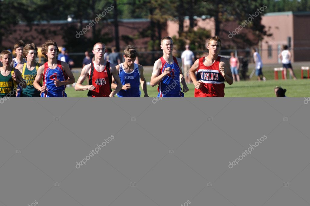 Teen Boys Running in a Long Distance High School Track Meet Race ...