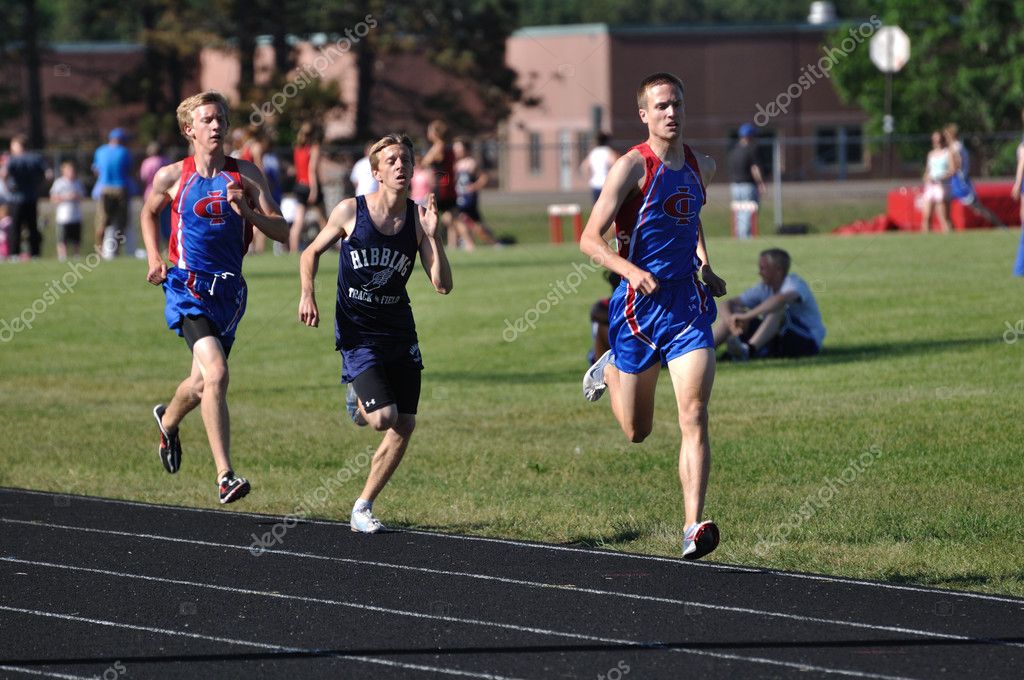 Teen Boys Running in a Long Distance High School Track Meet Race ...