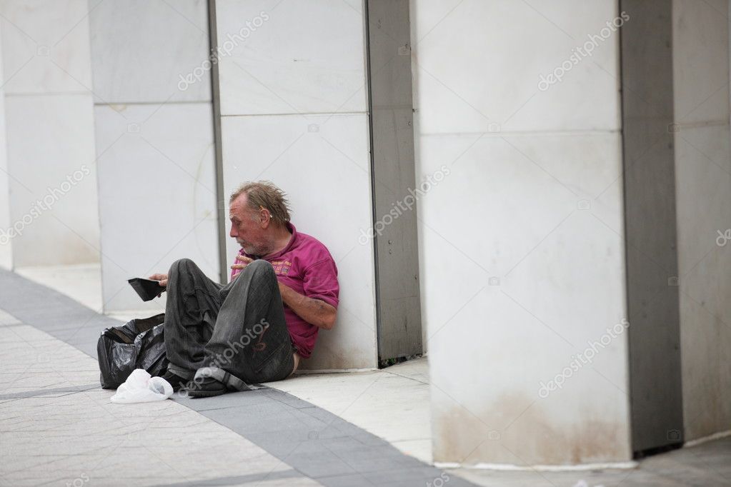 Homeless man sitting on the streets – Stock Editorial Photo © felixtm ...