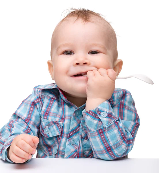 Little boy is being feed by his mother Stock Photo by ©Kobyakov 7415665