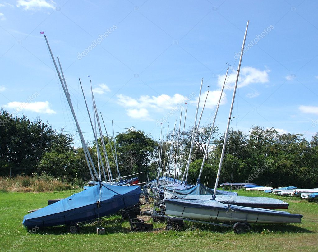 A Collection of Sailing Dinghys on Shore. #8560092 - Larastock