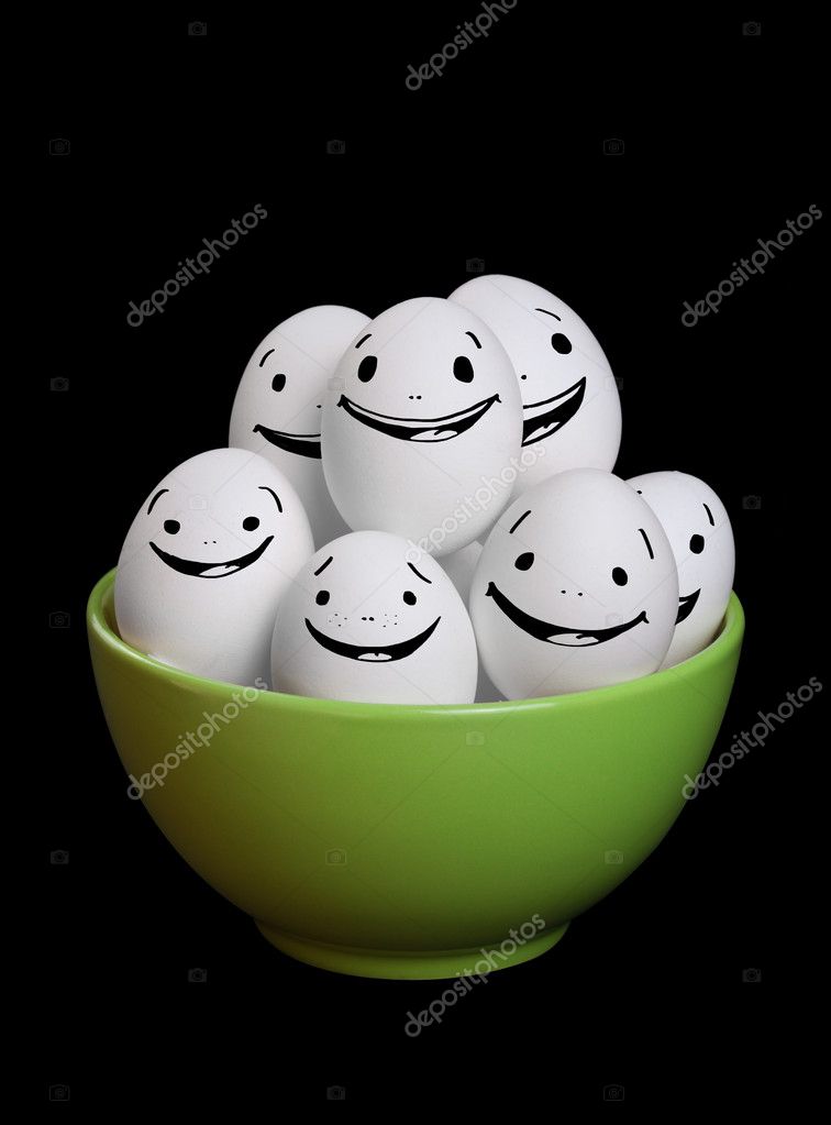 A group of funny and happy egg smiley collection in bowl with bl ...