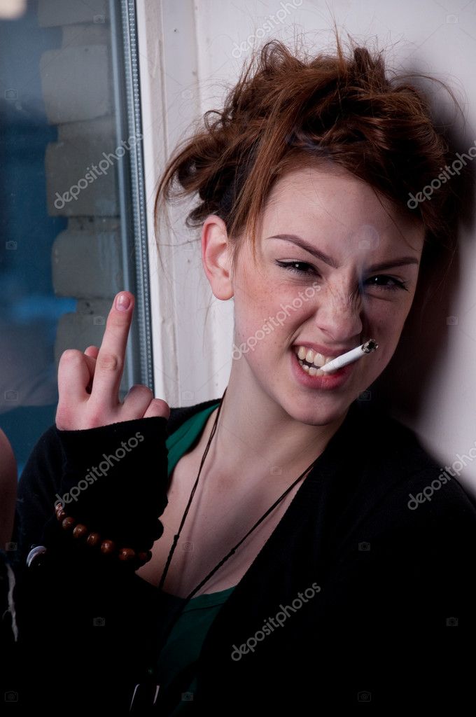 Beautiful young woman smoking on evening window. Stock Photo by ©markin ...