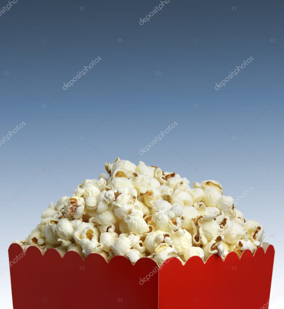 Box of popcorn and blue background — Stock Photo © mikdam #8881583