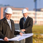 Two architects man point at construction site Stock Photo by ...