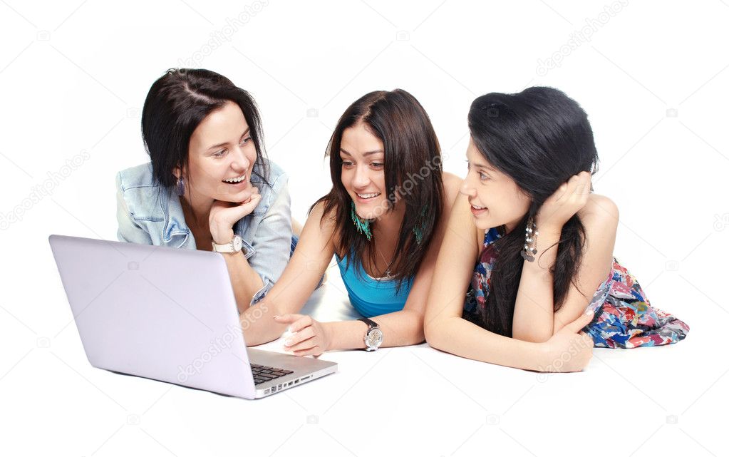 Three girls-students with laptop sitting on white background — Stock ...