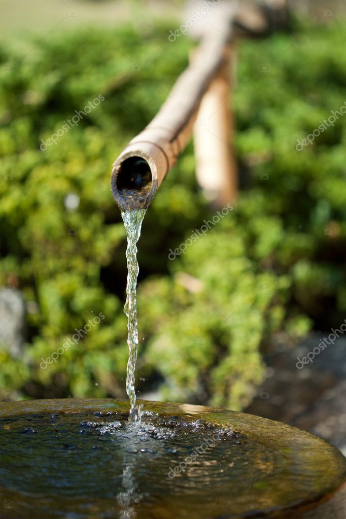 Bamboo tube and flowing water Stock Photo by ©foto76 9762391