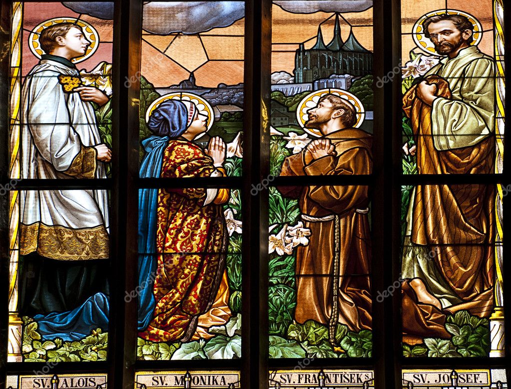 Stained glass window in old church with four saints person praying ...