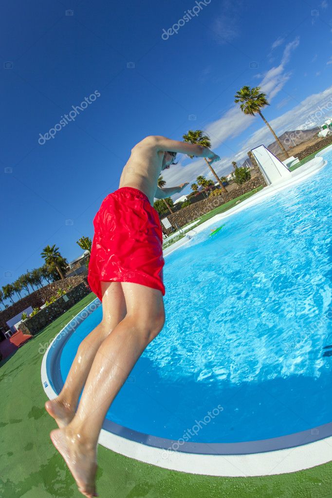 Boy jumping in the blue pool Stock Photo by ©Hackman 10106428