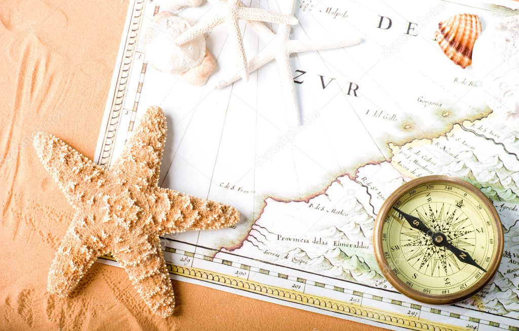 Old map and compass on sand background Stock Photo by ©xavigm99 9126440