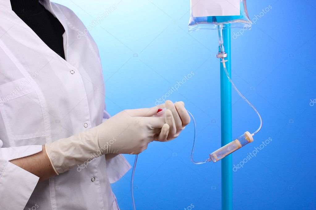 Nurse doing infusion on blue background — Stock Photo © belchonock ...