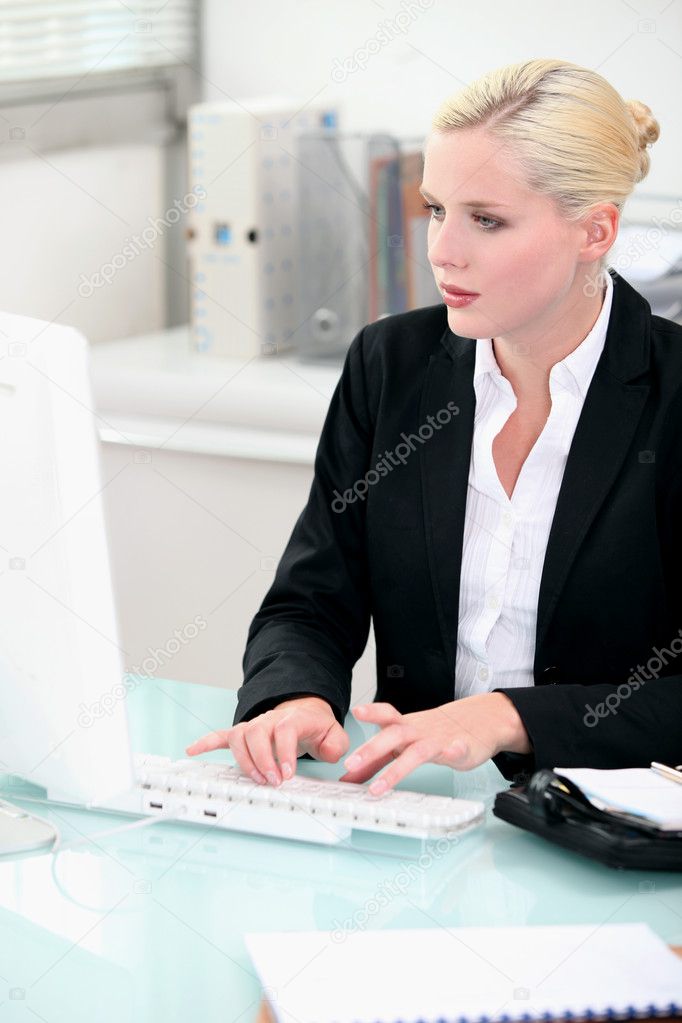 Blonde woman working at a desktop computer — Stock Photo ...