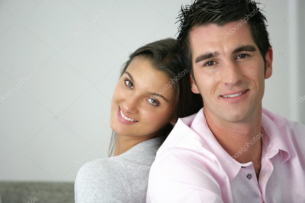Young couple sitting back to back — Stock Photo © photography33 #8965415