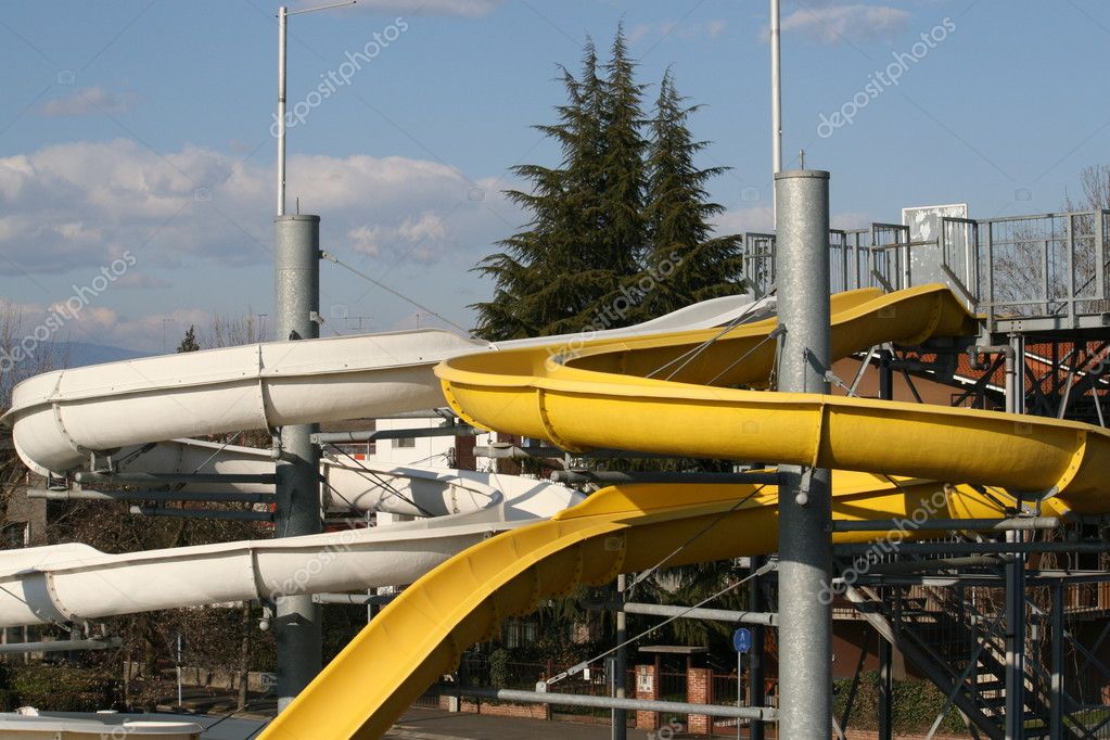 White and yellow slides into a pool for the amusement of children ...