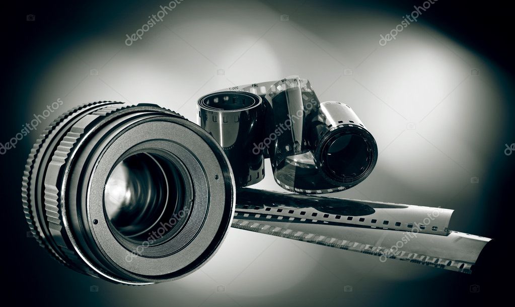 Lens & film strip on dark background — Stock Photo © kobets #8904446