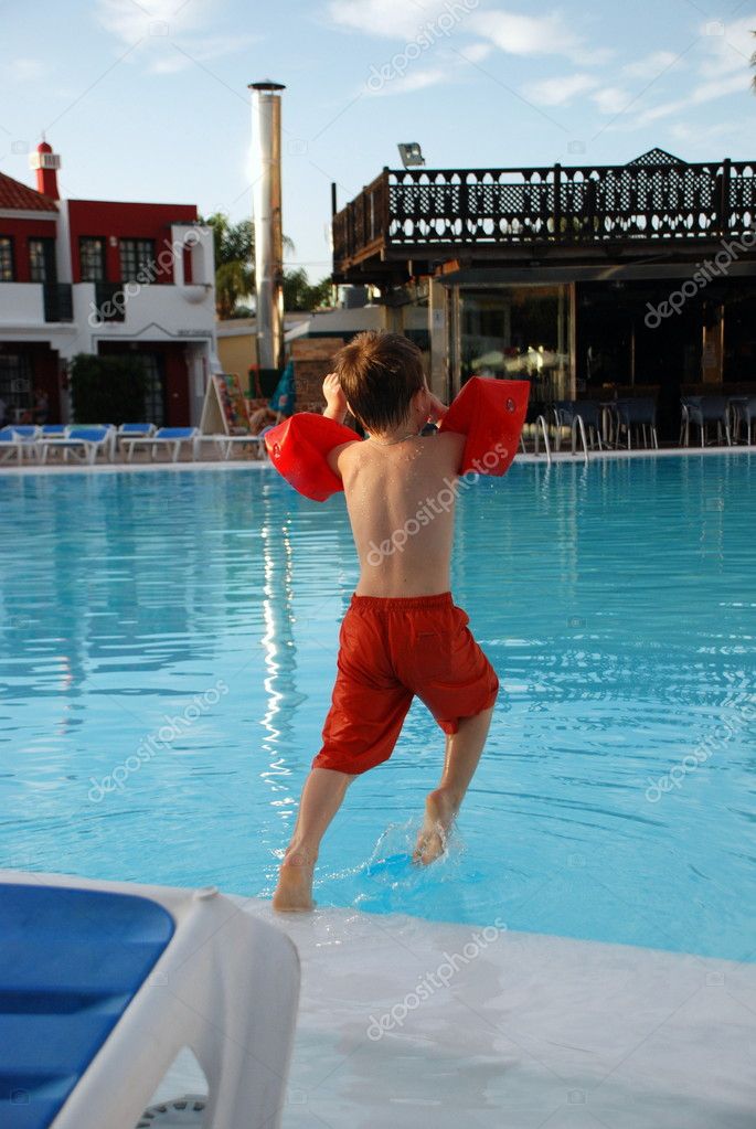 Boy jumping into the swimming pool — Stock Photo © mariacarlson #9298864