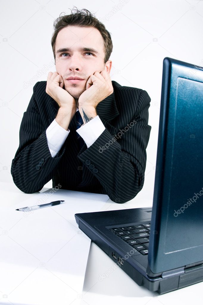 Male model as businessman thinking or dreaming near computer in his ...