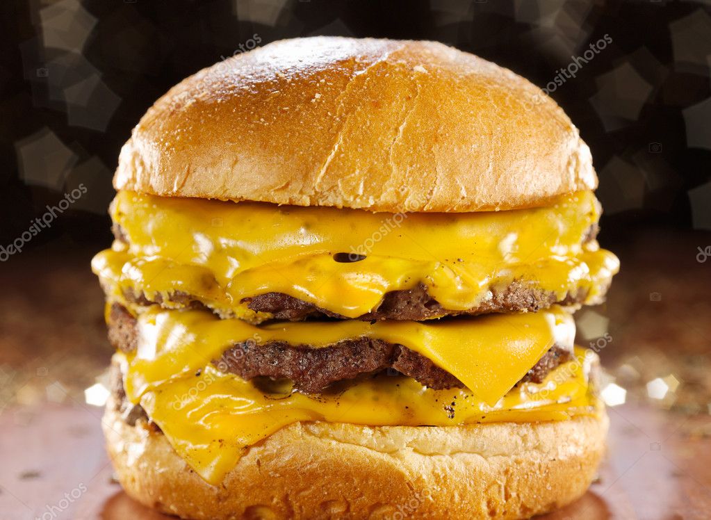 Big cheeseburger with melted cheese and glittery background. — Stock ...