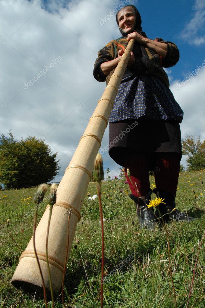 Old woman playing on alpenhorn – Stock Editorial Photo © salajean #8341538