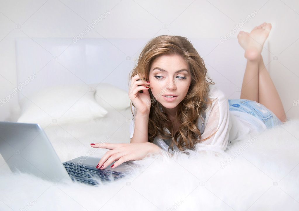 Lovely young girl blonde with laptop in bedroom lying — Stock Photo ...