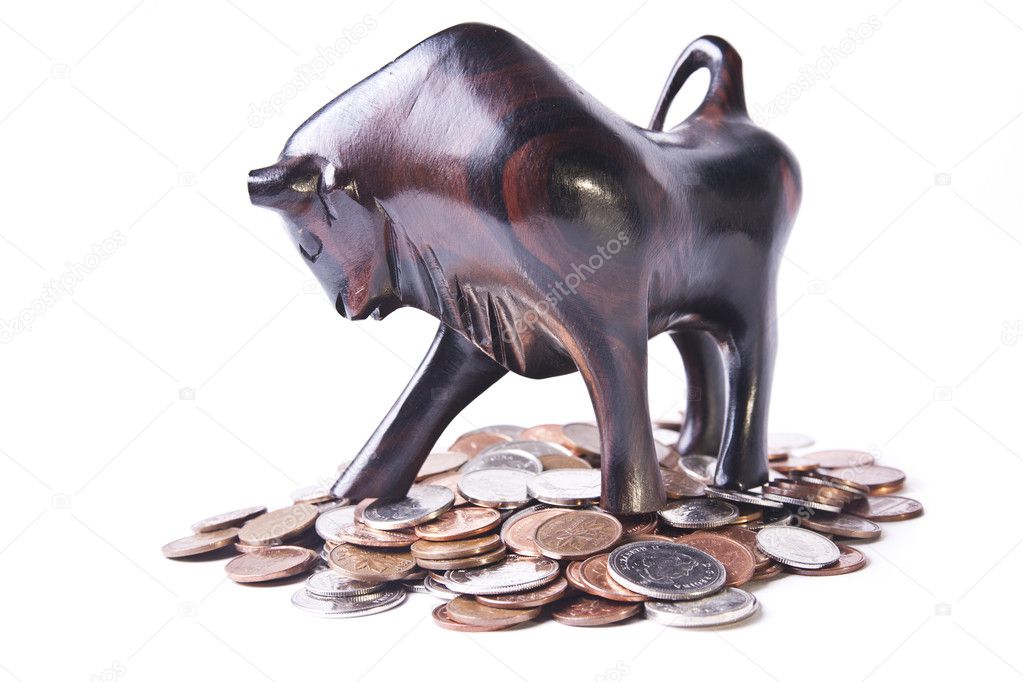 A strong, triumphant bull atop a pile of coins, signifying an op Stock ...