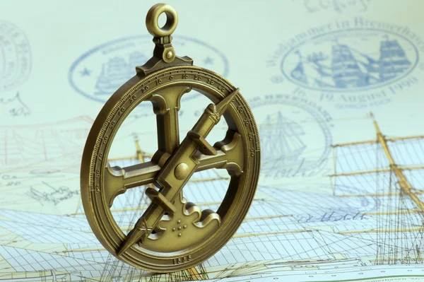 Ship wheel compass map | Compass in a ship's wheel over a map — Stock ...