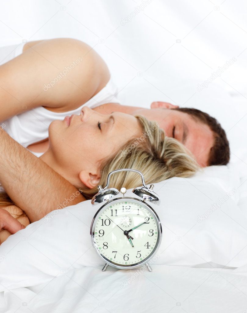 Couple in bed with focus in alarm clock Stock Photo by ©Wavebreakmedia ...